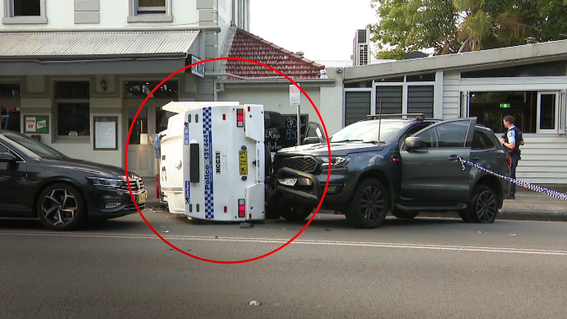 WATCH: Manhunt underway after police car flipped